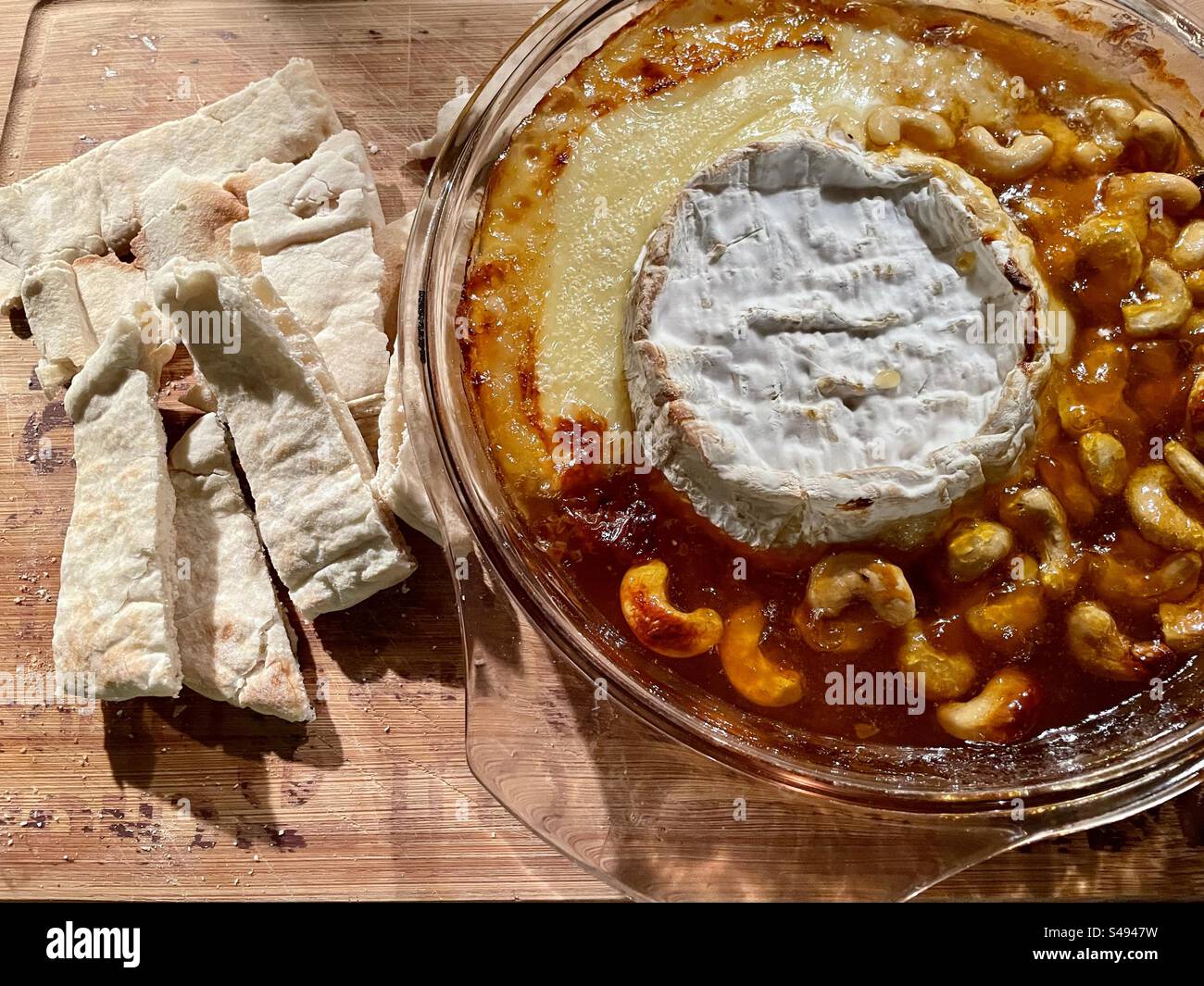 Baked Camembert with apricot conserve and cashew nuts, served with ...