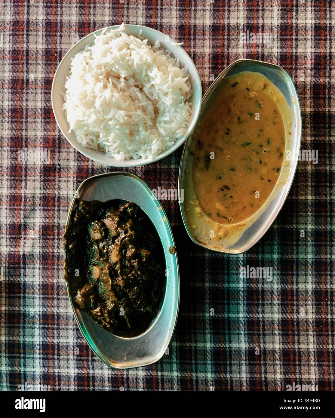 Rice, daal, and spinach with potato served for lunch Stock Photo - Alamy