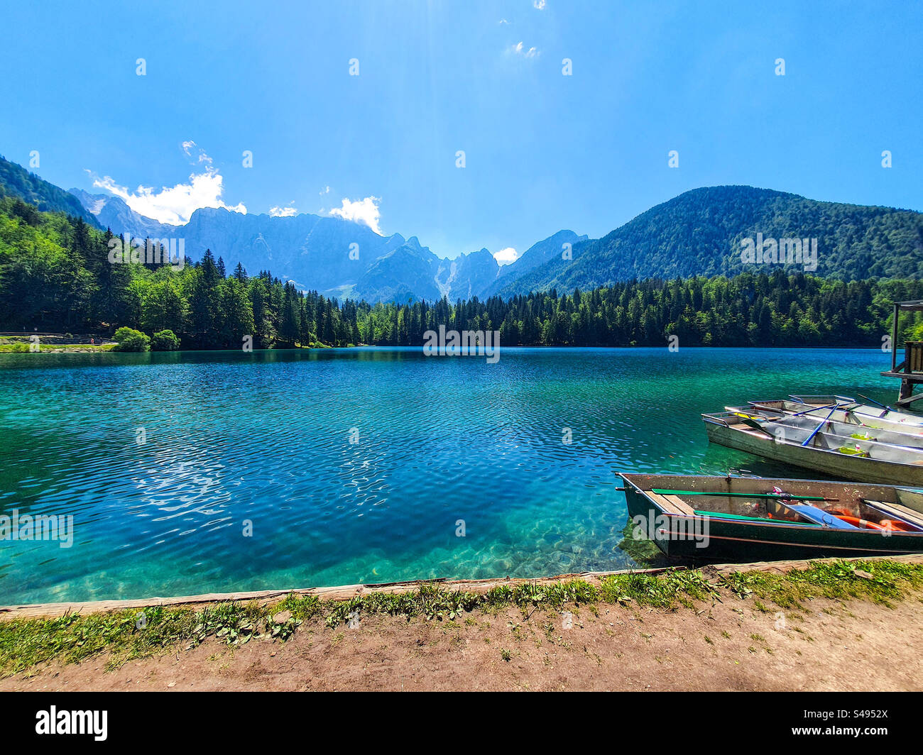 Laghi di Fusine, a beautiful azure lake in Italy, with Italian Alps in ...