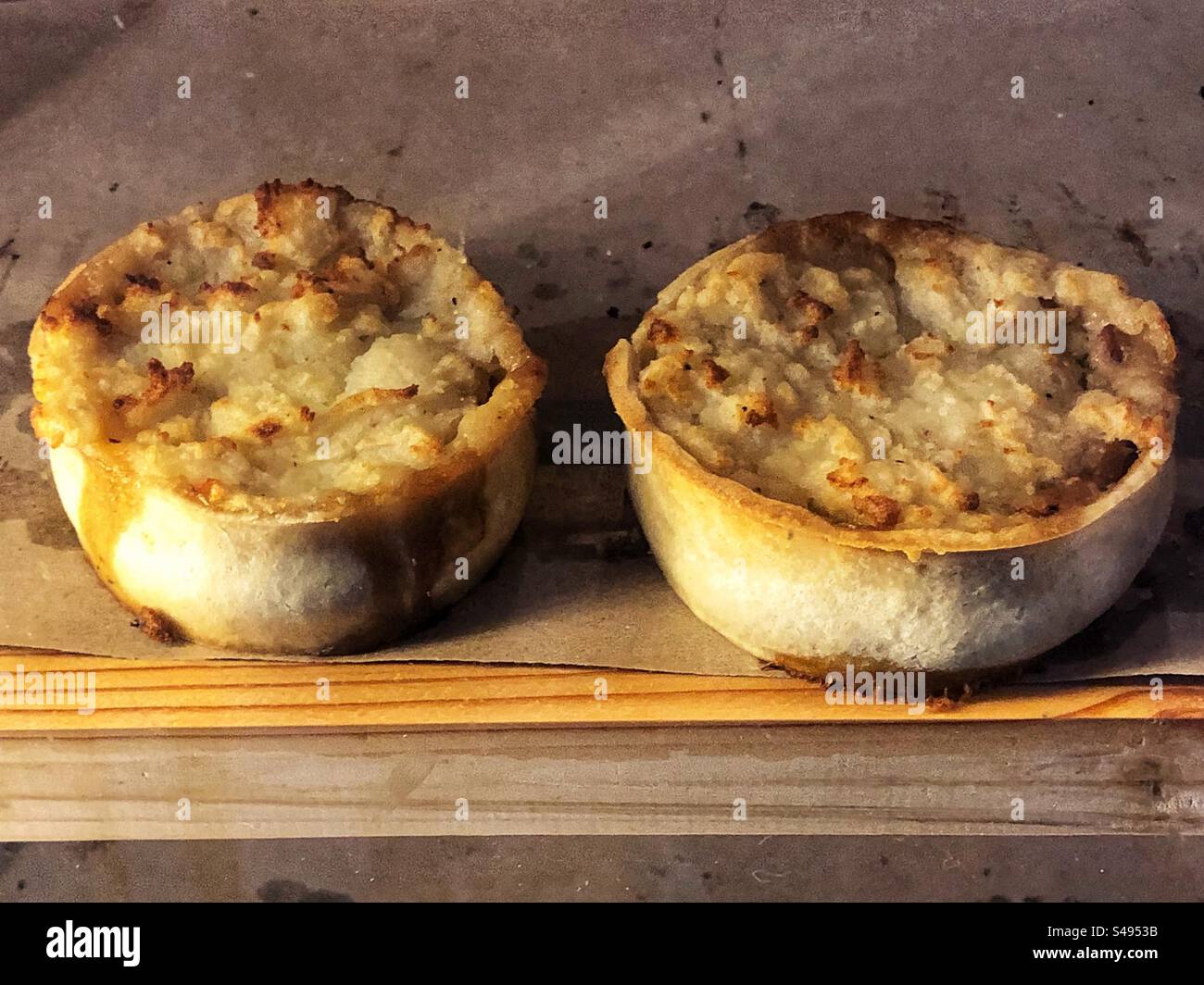 Meat and potato pie in bakery window Stock Photo - Alamy