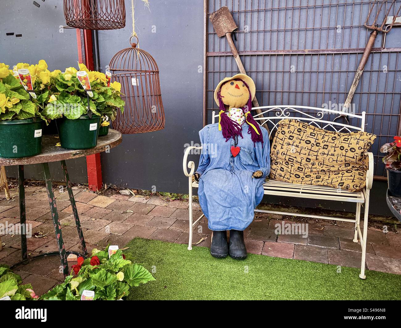 Life sized Raggedy Ann scarecrow doll sitting on bench with potted ...