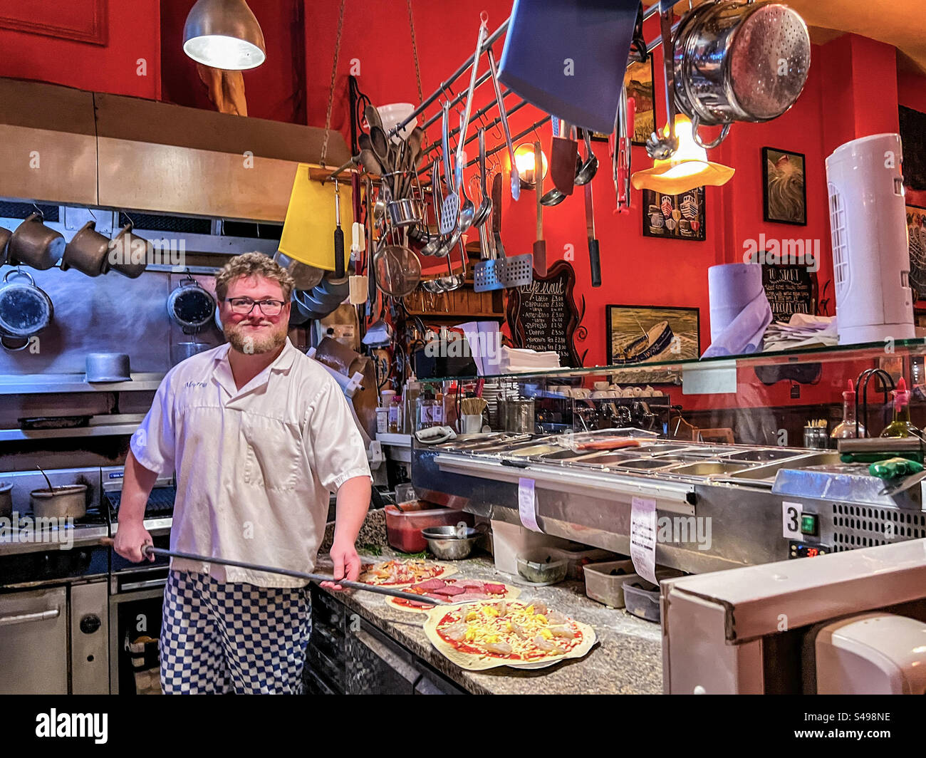Pizza chef making pizza at Moutreys Restaurant in Whitby Stock Photo ...