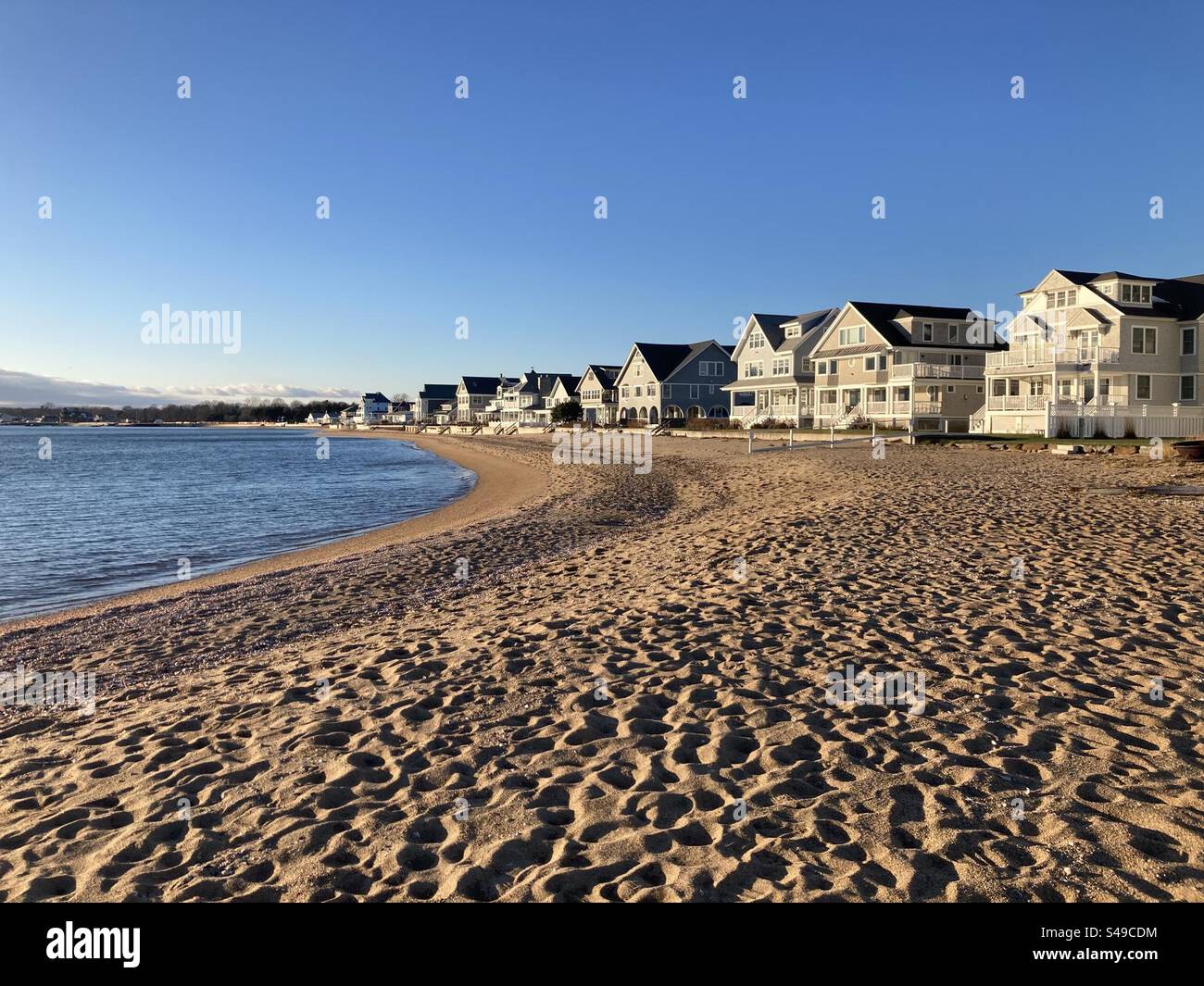 Luxury homes along the coastline in Madison, Connecticut, USA. Sun and ...