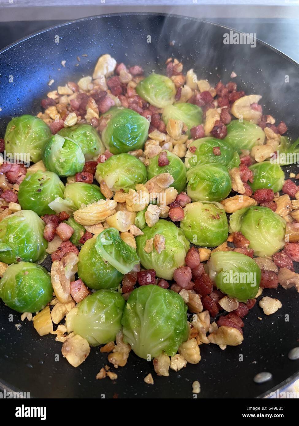 Christmas sprouts cooking with roasted chestnuts and bacon Stock Photo ...
