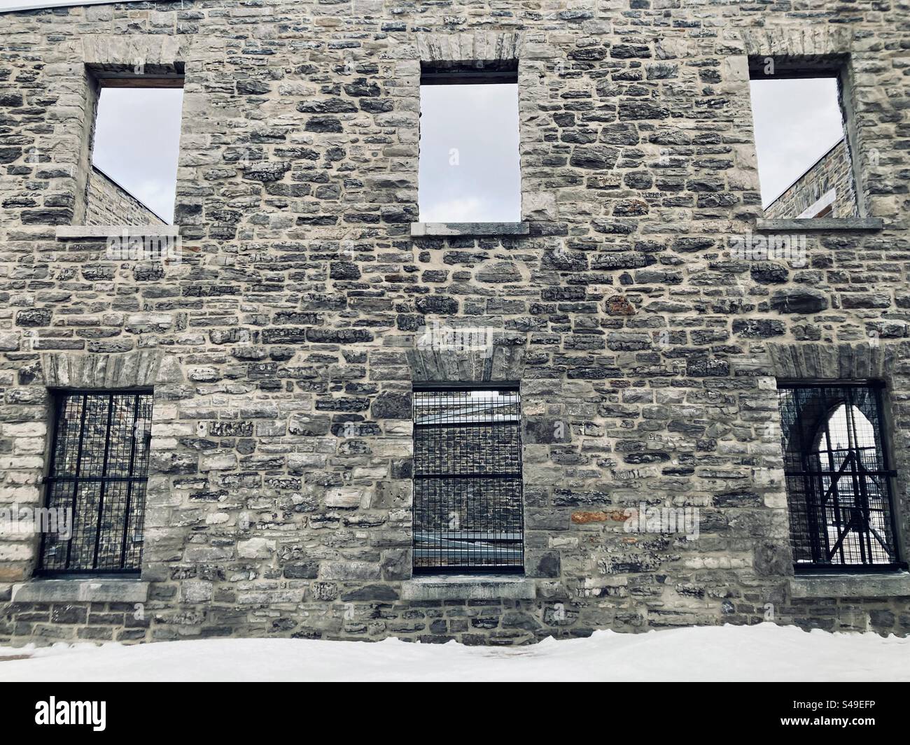 The exterior walls of a turn of the century stone building Stock Photo ...