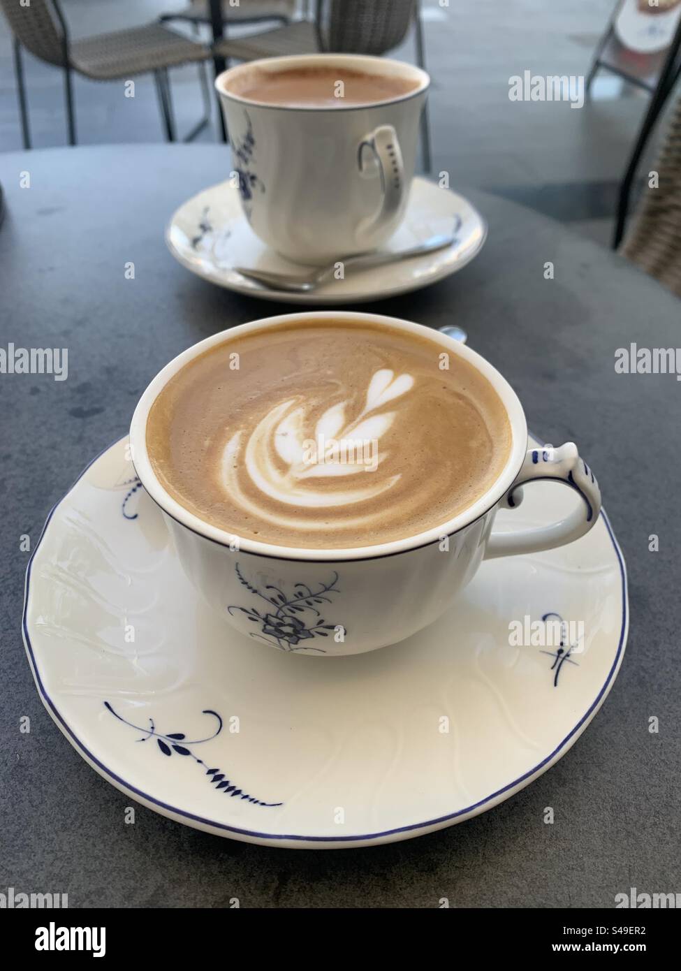 A cup of cortado coffee served in an elegant cup and saucer on an ...