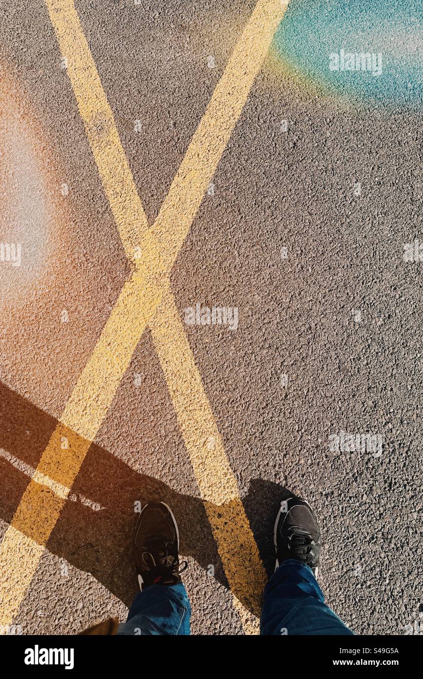First person view of two feet wearing black snickers in front of a ...