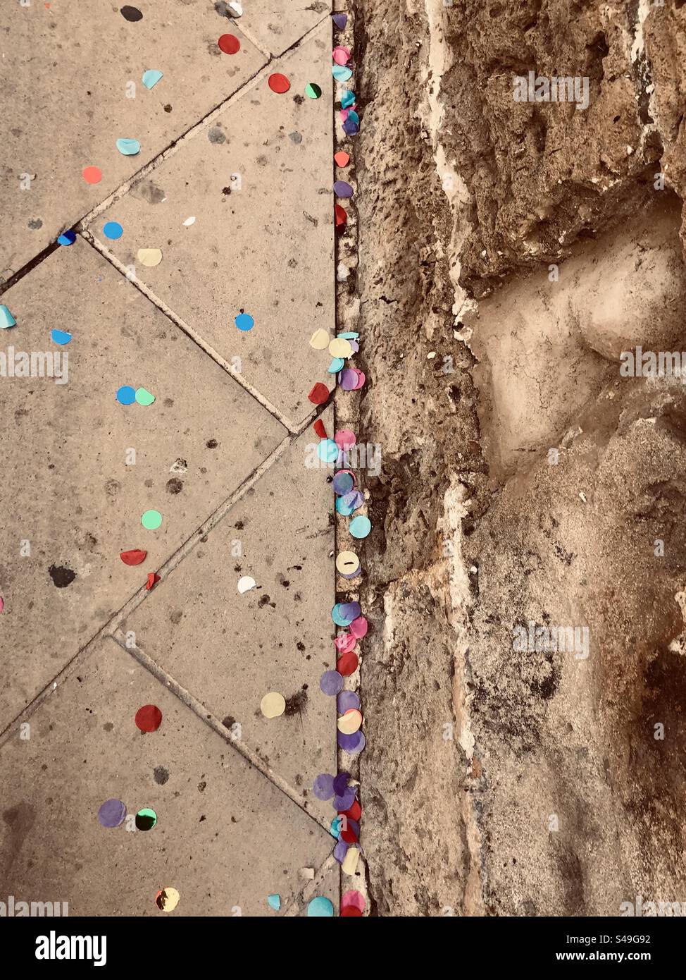 Confetti on the street in a vertical line Stock Photo - Alamy