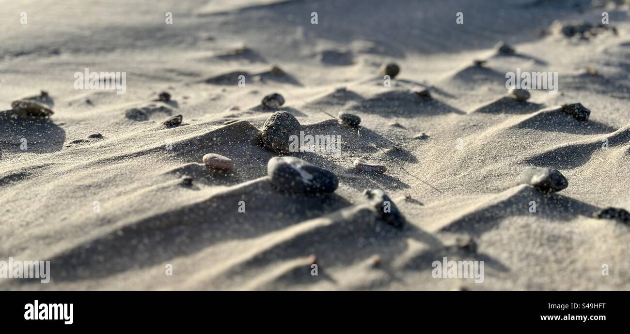 Sand in Wind with Stones at the Sunny Beach Stock Photo - Alamy