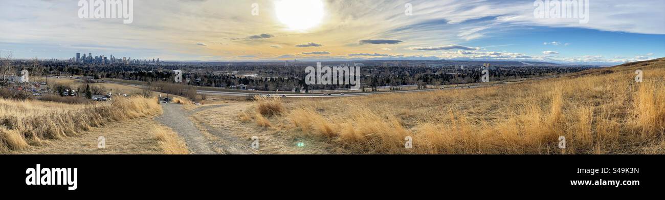 A panoramic view down a trail in Nose Hill Park toward the city of ...