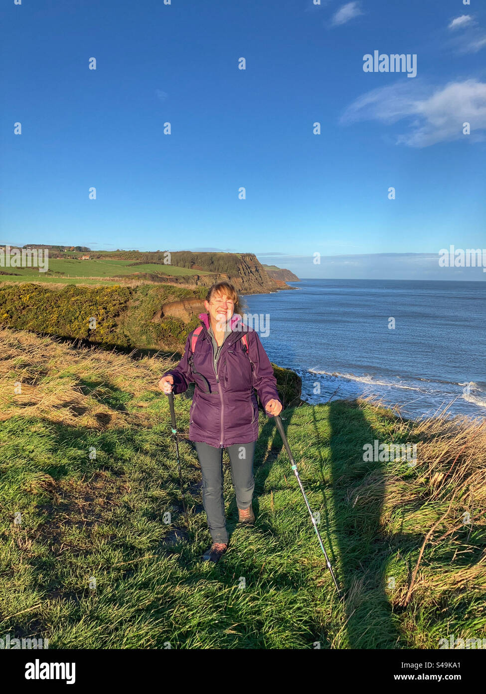 Woman walking on the Cleveland Way coastal path Stock Photo - Alamy
