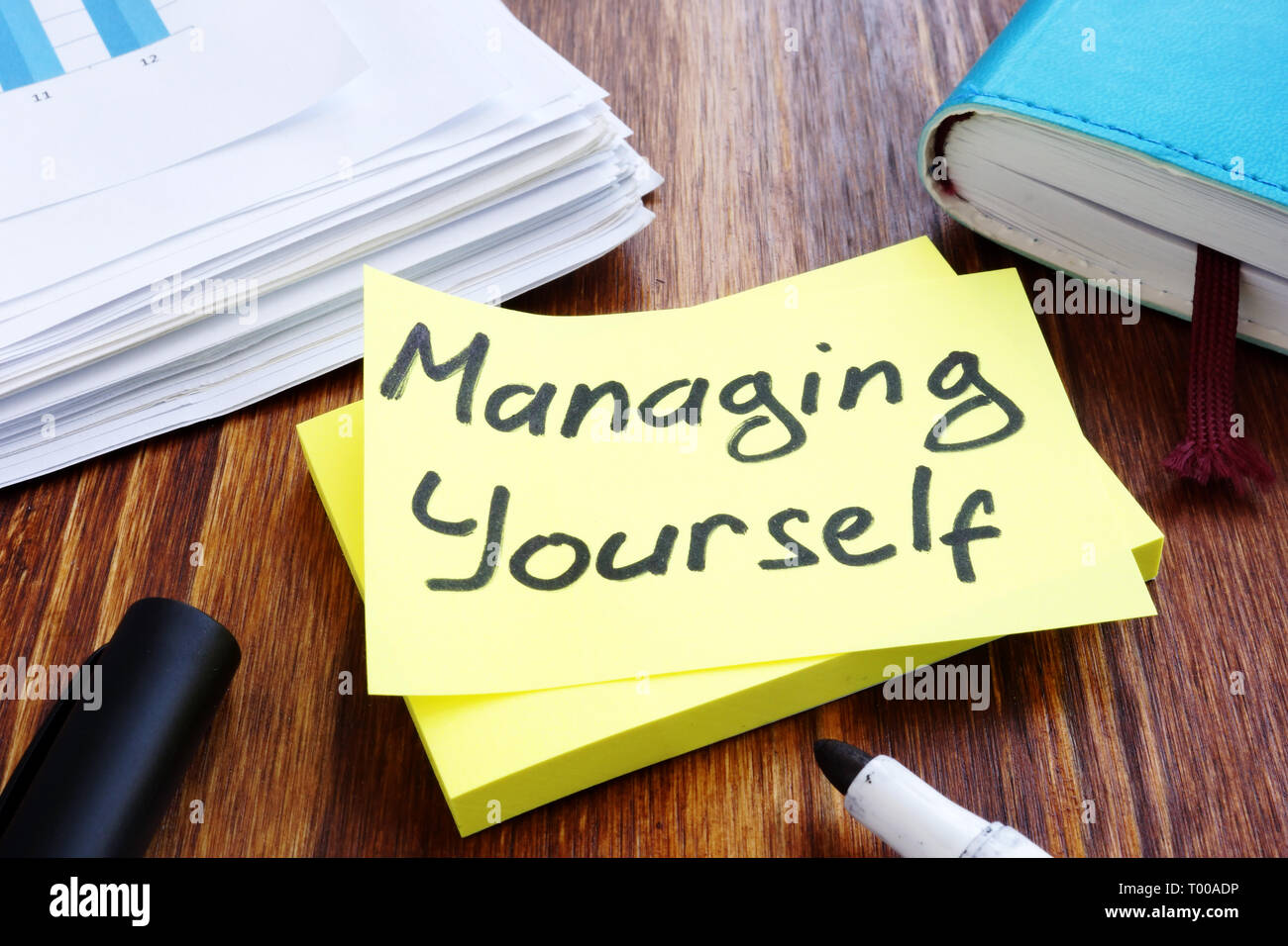 Managing yourself. Office table with papers. Self management concept ...