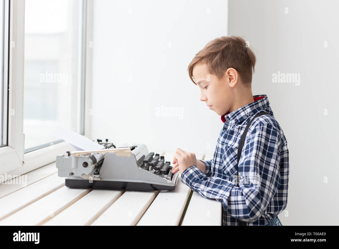 World day of the writer concept - Boy with an old typewriter over ...