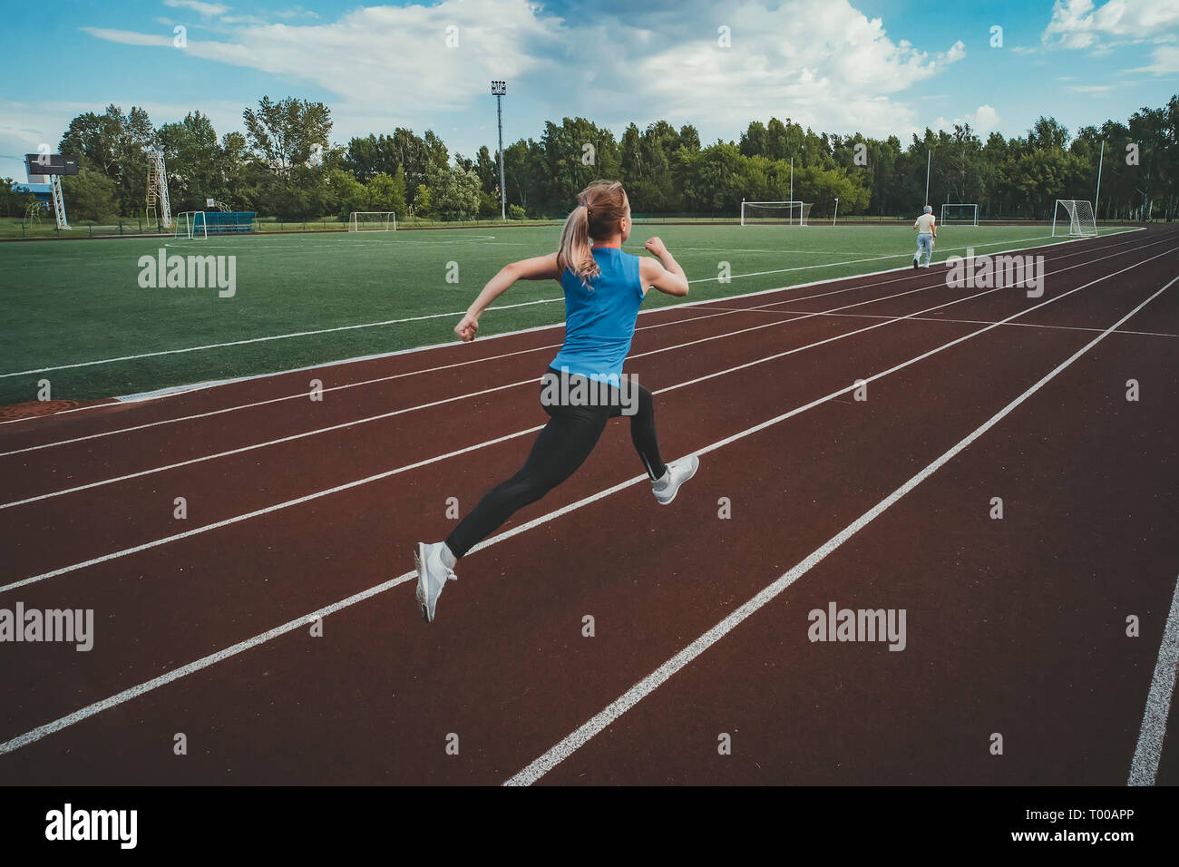 young fitness woman runner running on stadium track. Athletics at the ...