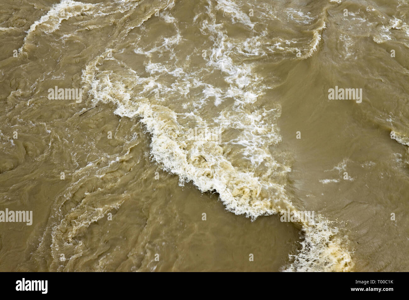 Raging waters and murky. Flooding after several days of rain Stock ...