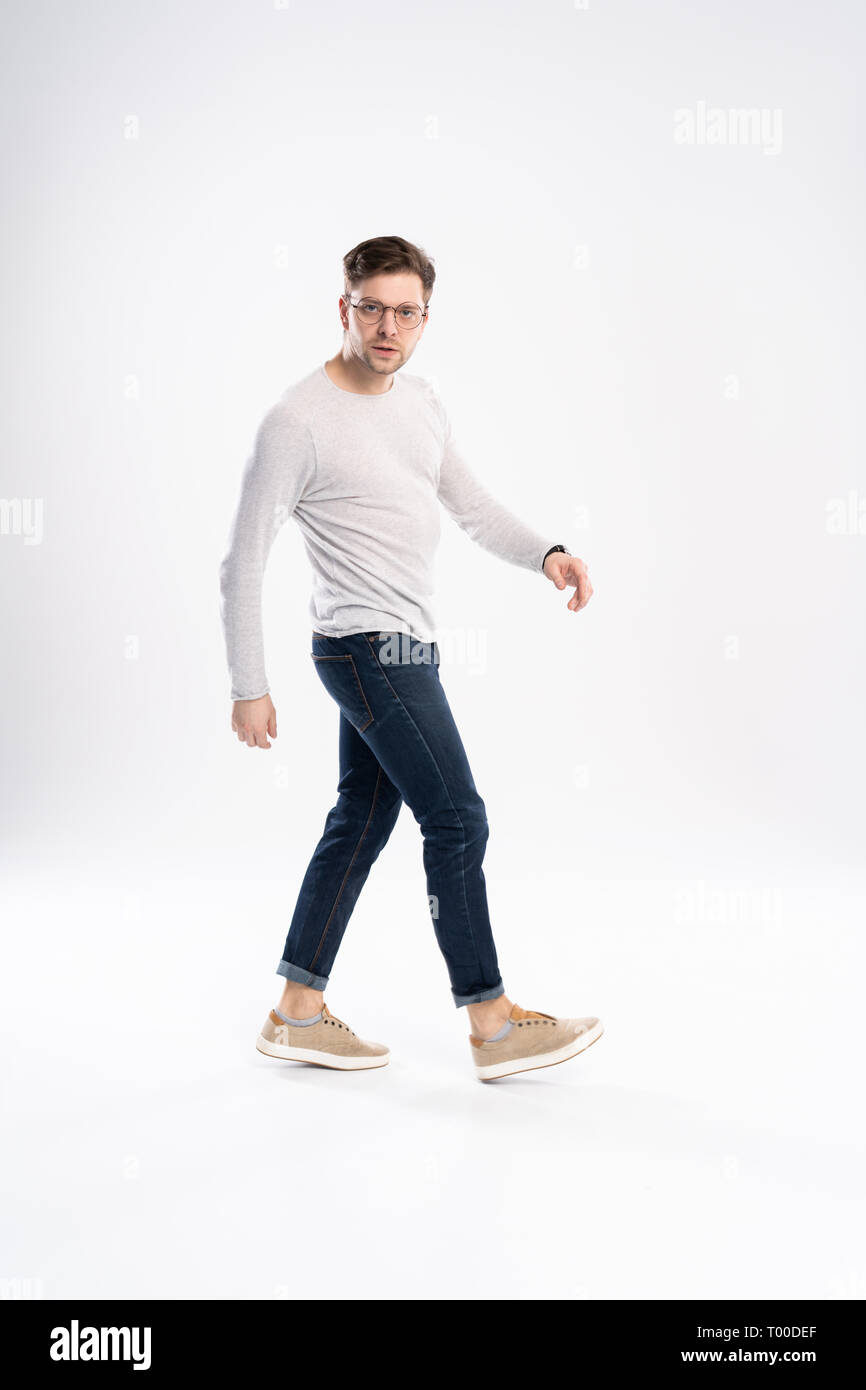 Side view of a young fashion man walking on isolated background Stock ...