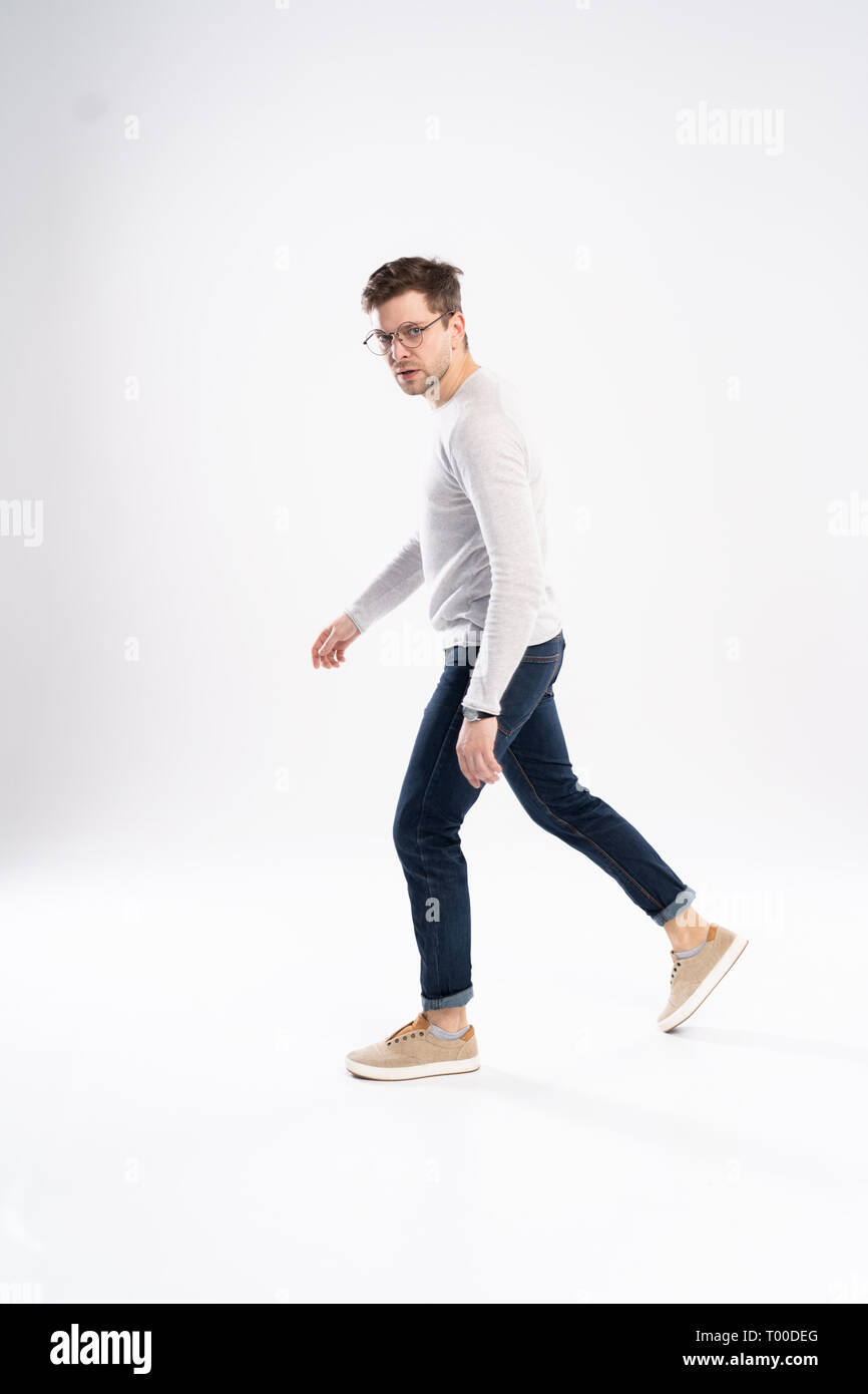 Side view of a young fashion man walking on isolated background Stock ...