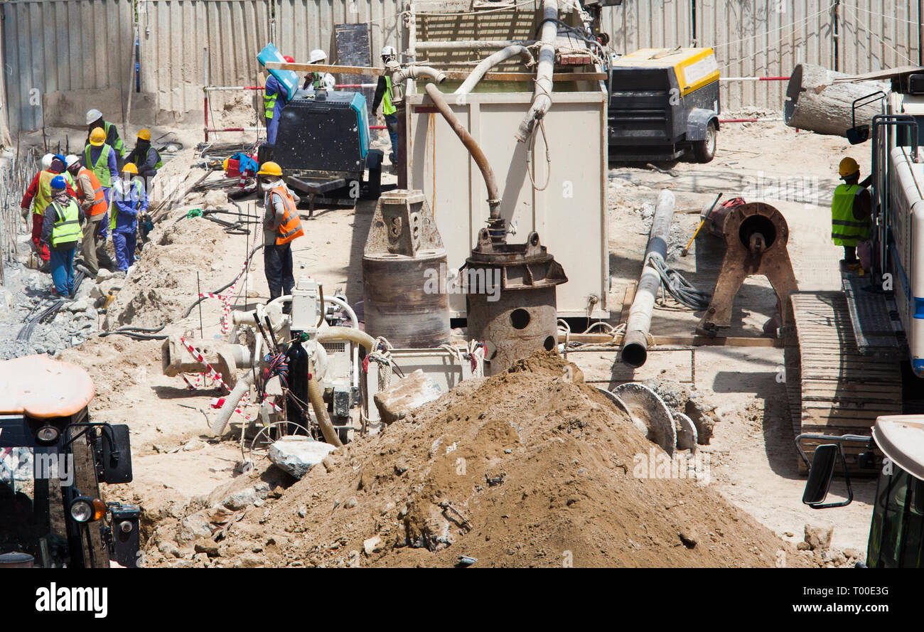 workers and machines on a construction site Stock Photo - Alamy