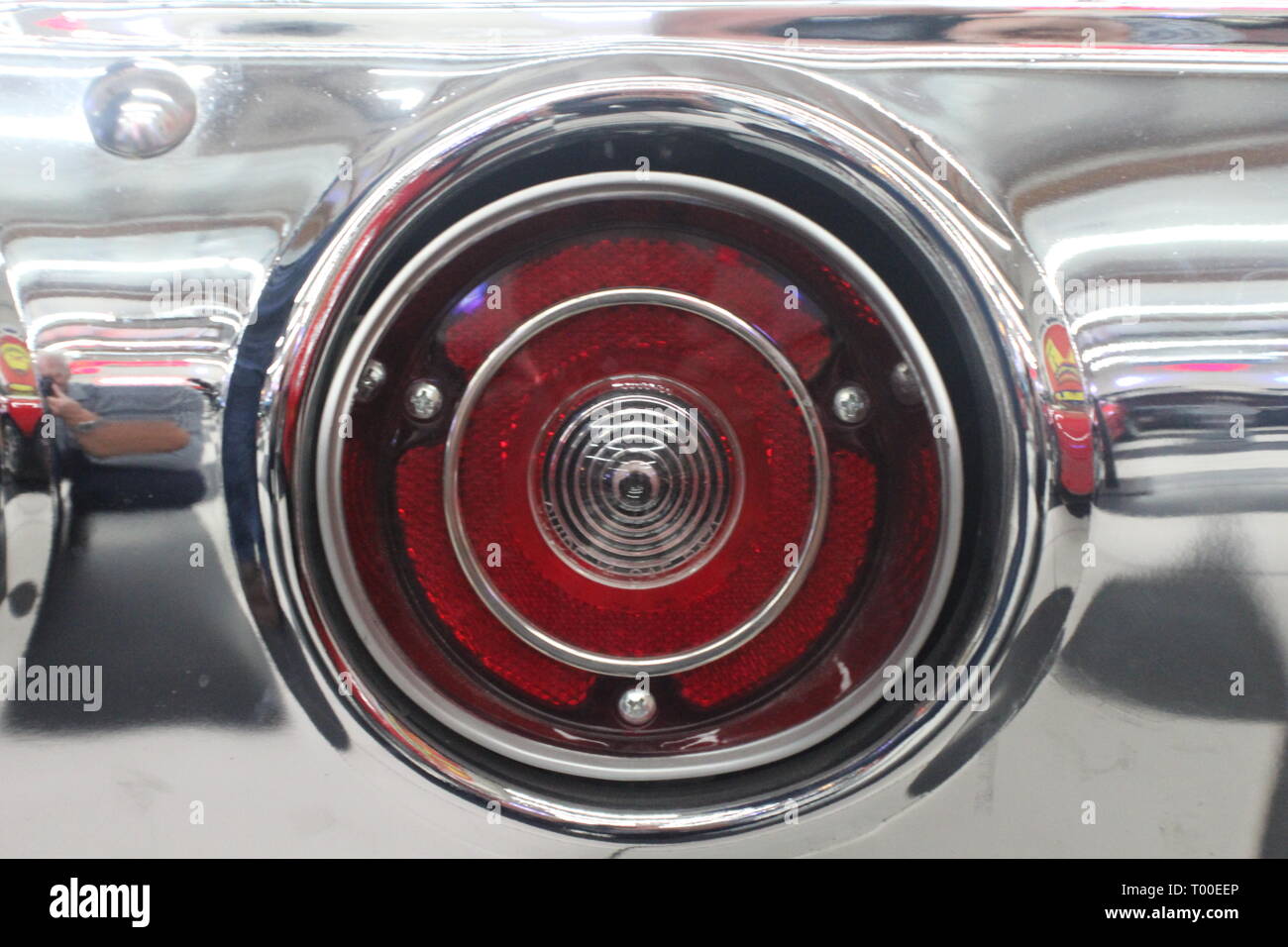 Round Tail light in chrome bumper Stock Photo - Alamy