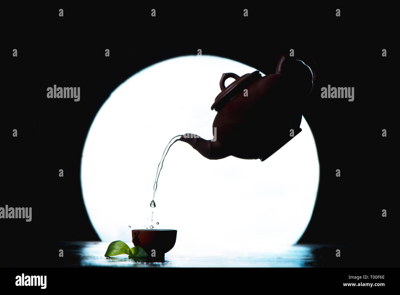 Flying tea pot silhouette against a full Moon silhouette. Asian tea ...