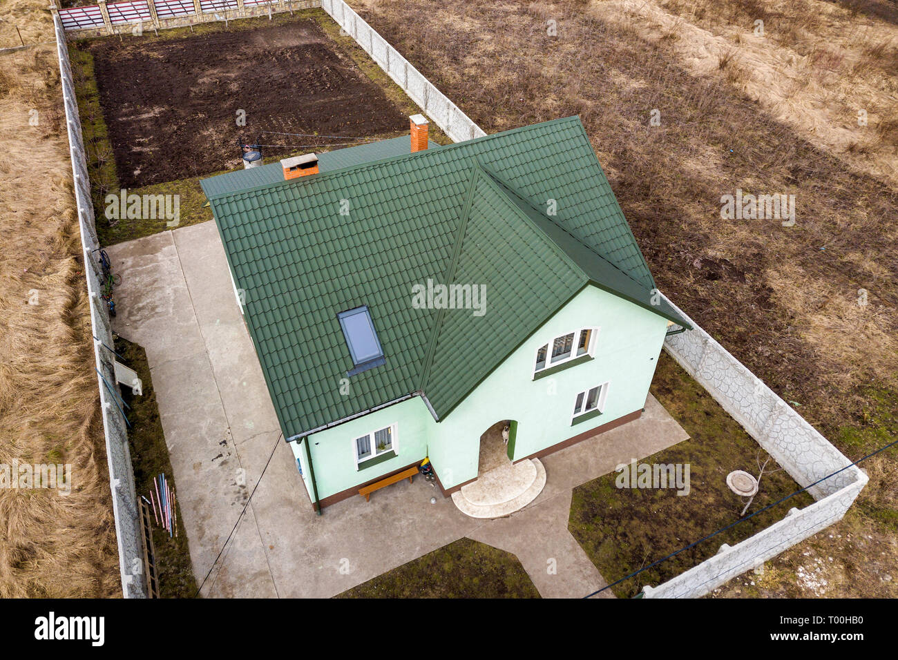 Aerial top view of new residential house cottage with brick chimney and ...