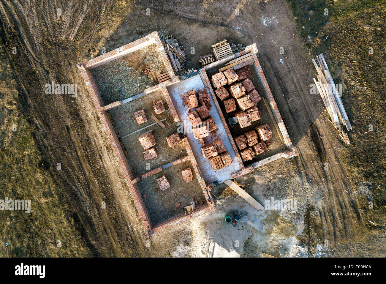 Aerial view of building site. Trenches dug in ground and filled with ...