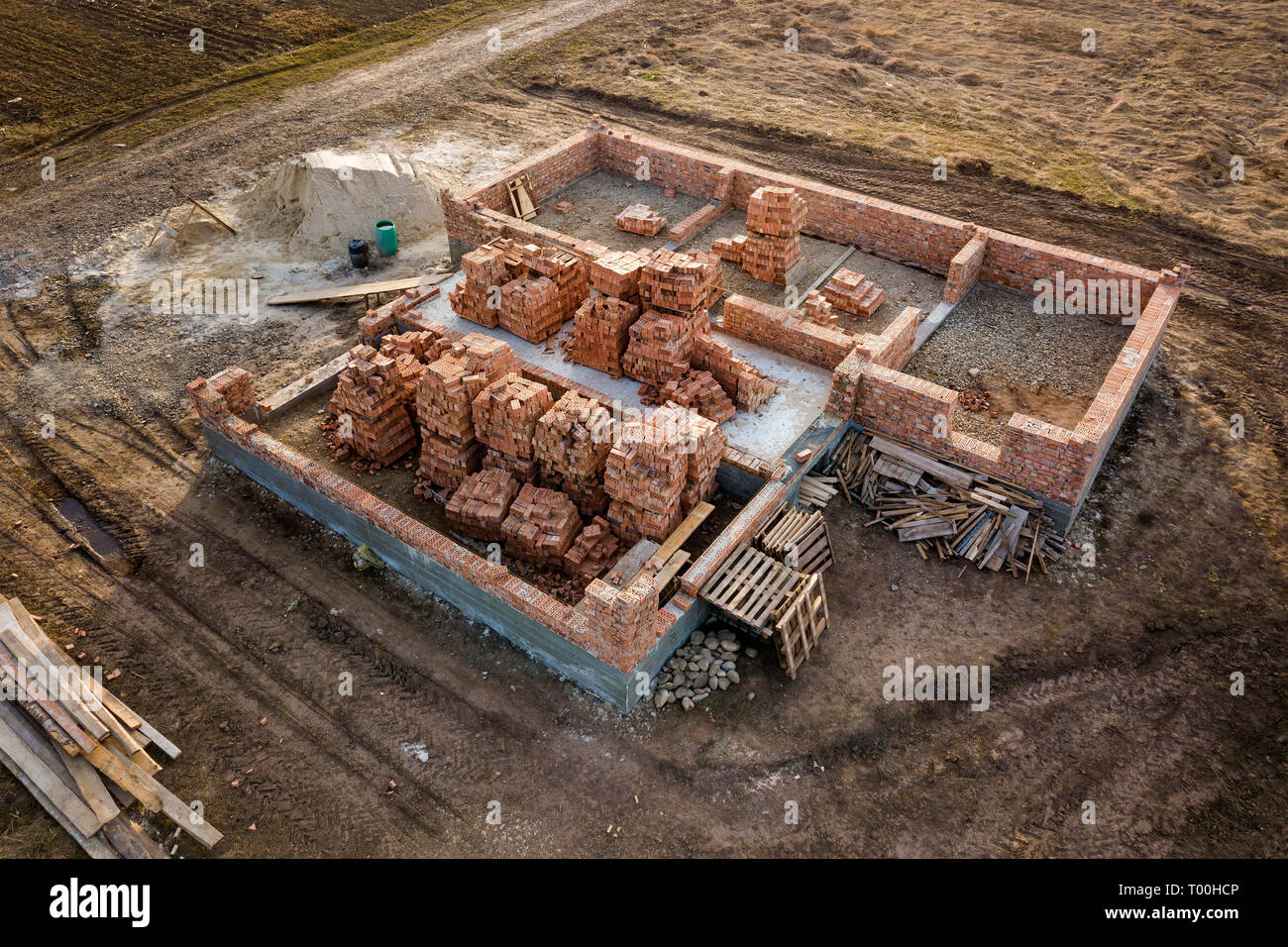 Aerial view of building site. Trenches dug in ground and filled with ...