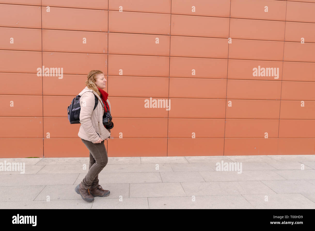 Full length side view portrait of trendy caucasian photographer woman ...