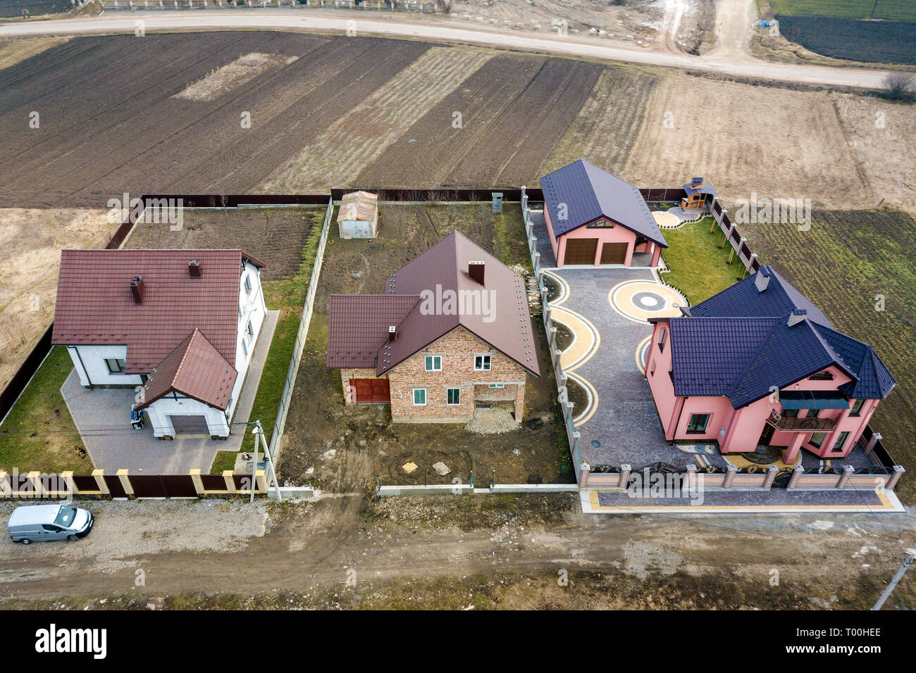 Aerial top view of suburb area with nice houses and cars on sunny day ...