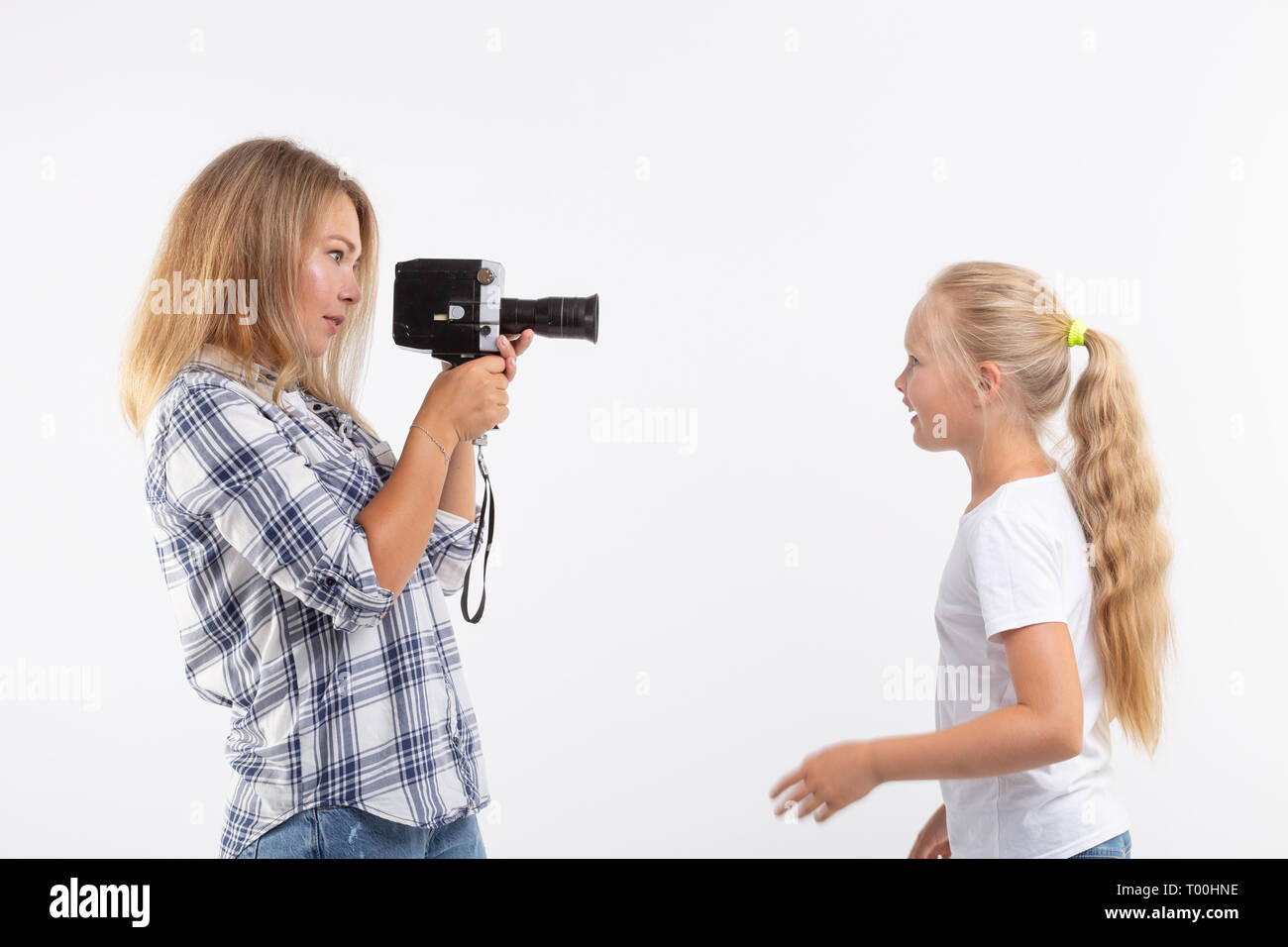 Photo, photographer and retro camera concept - young woman using ...