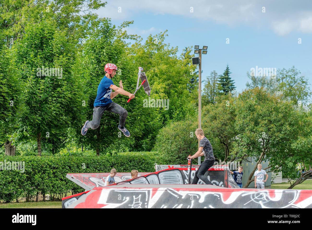 Moscow, Russia - June 21, 2018: Young man with a scooter jumping on the ...