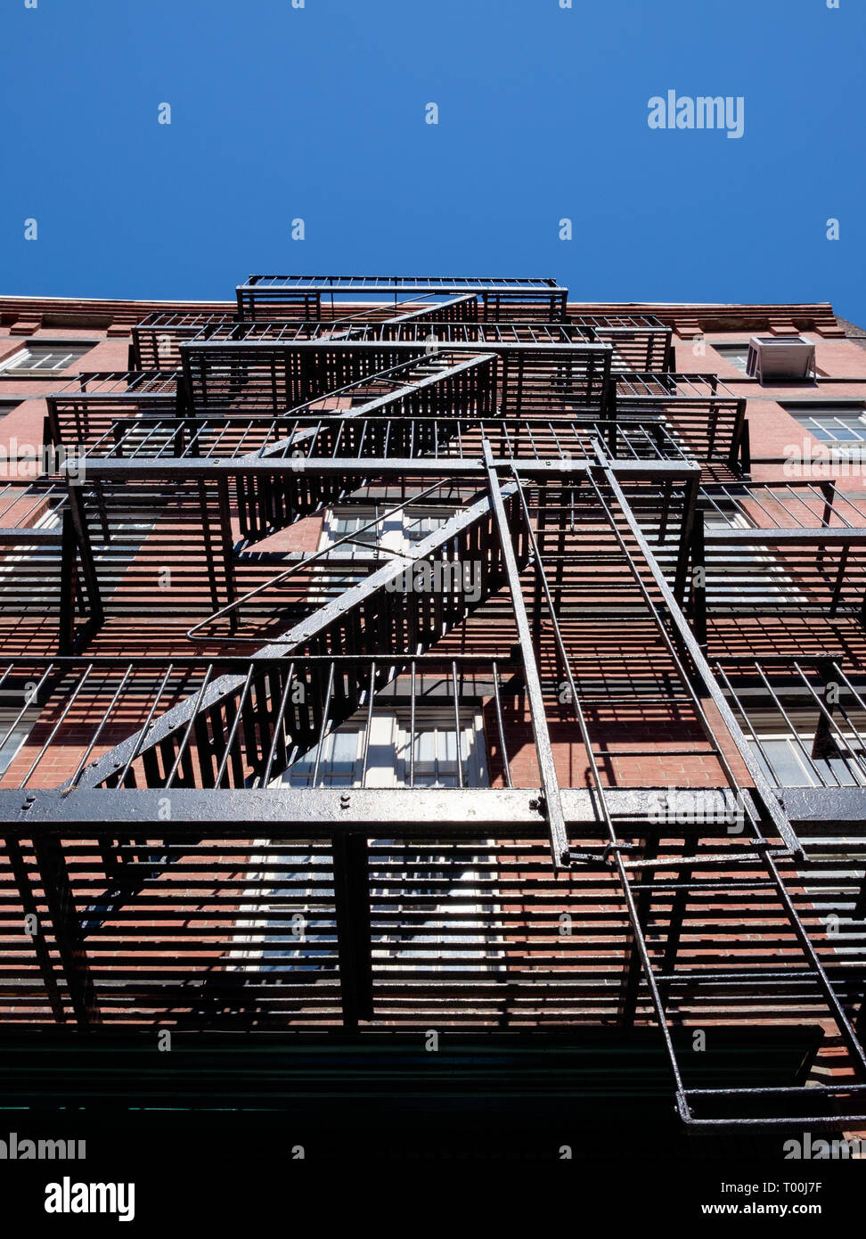 Iconic metal fire escapes on outside of building in Manhattan, New York ...
