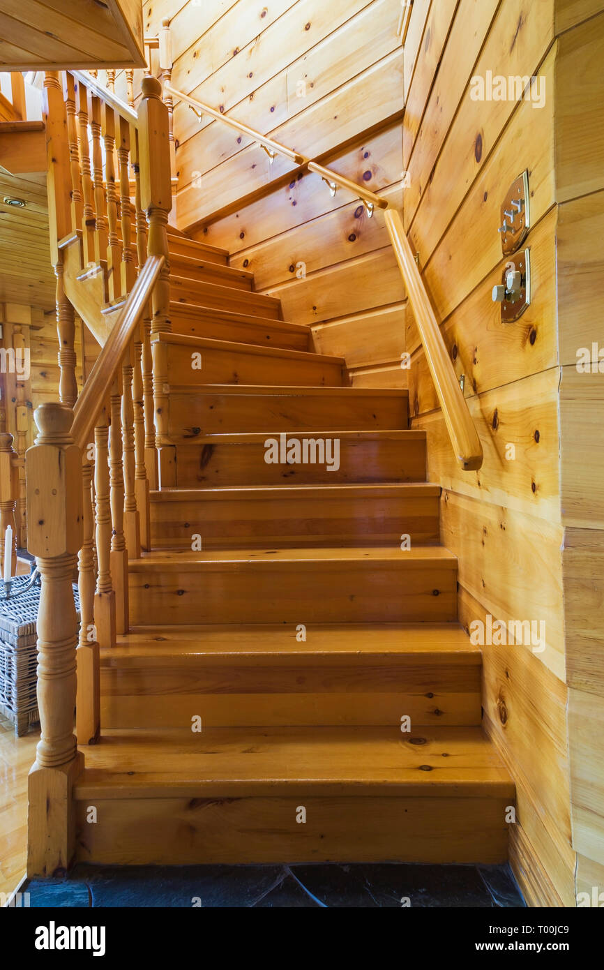 Pinewood staircase leading to upstairs floor from living room inside a ...