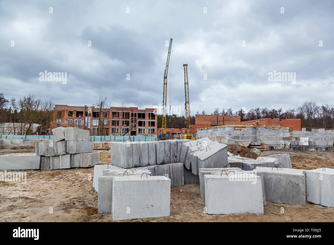 Construction site, tools, wheel barrow, sand and bricks at new house ...