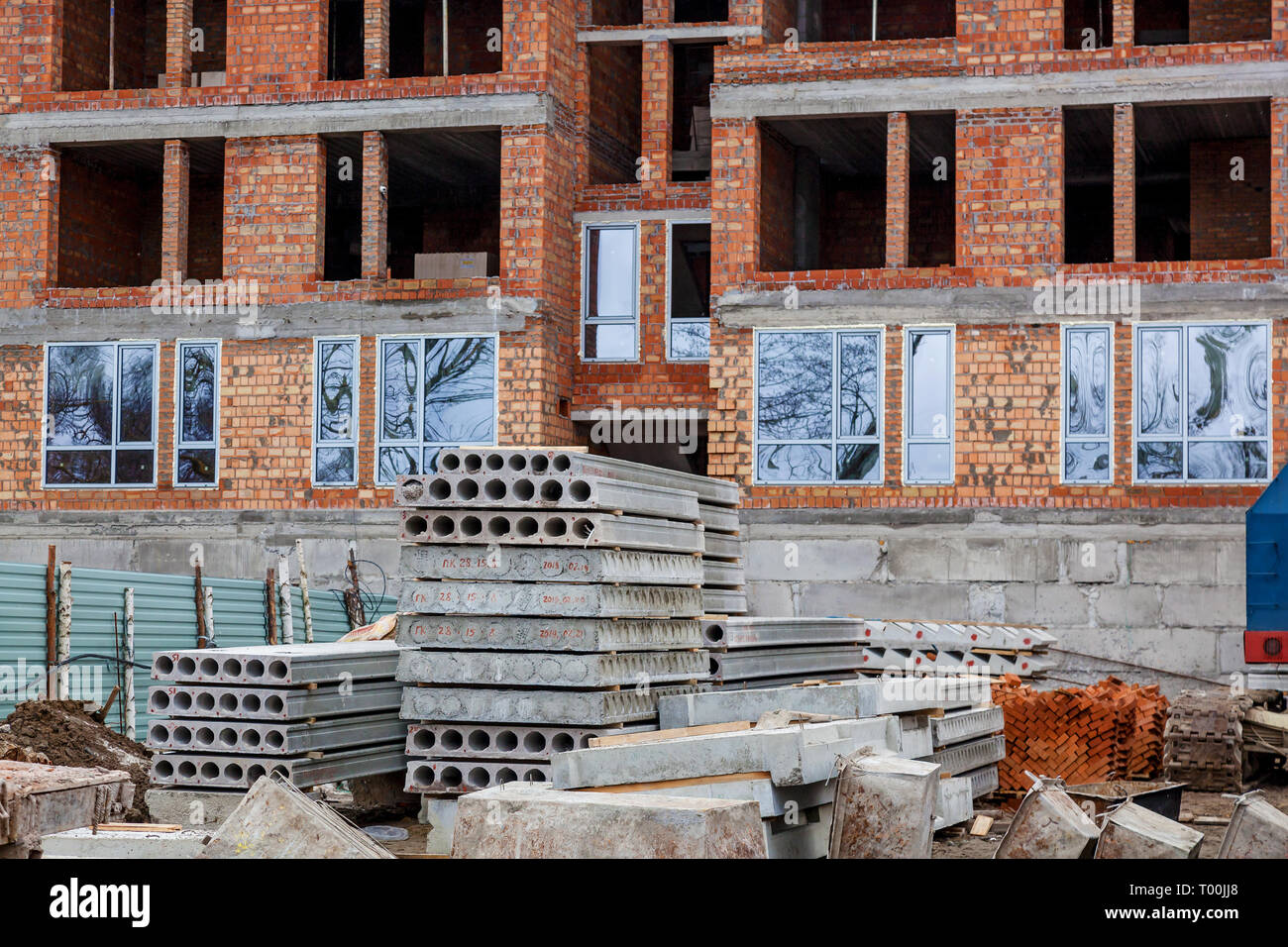 Construction site, tools, wheel barrow, sand and bricks at new house ...