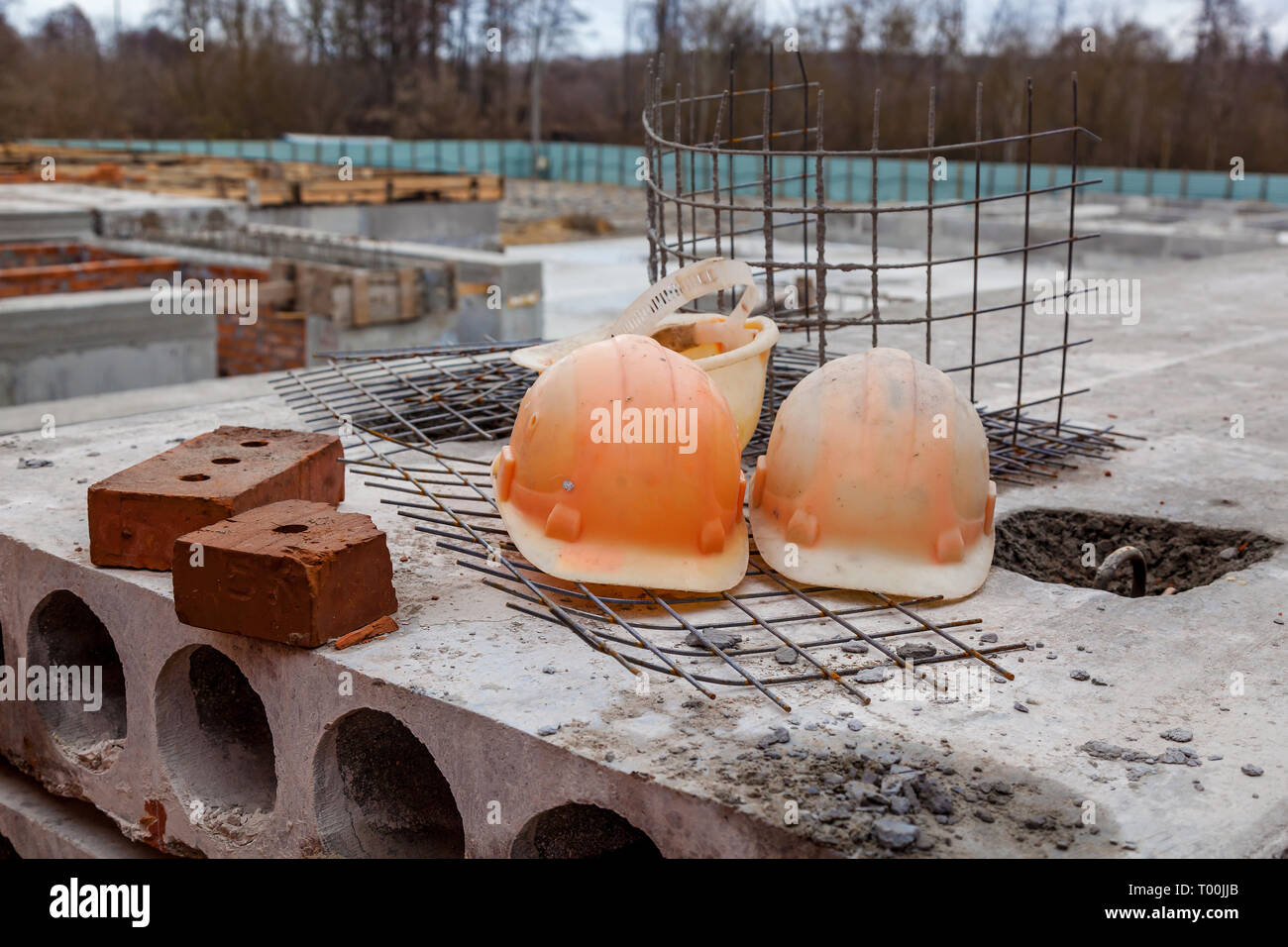 Construction site, tools, wheel barrow, sand and bricks at new house ...