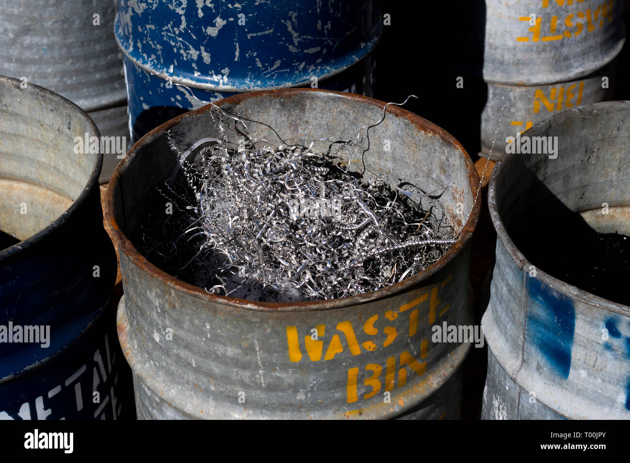 Metal waste bin storage area outside engineering works awaiting ...