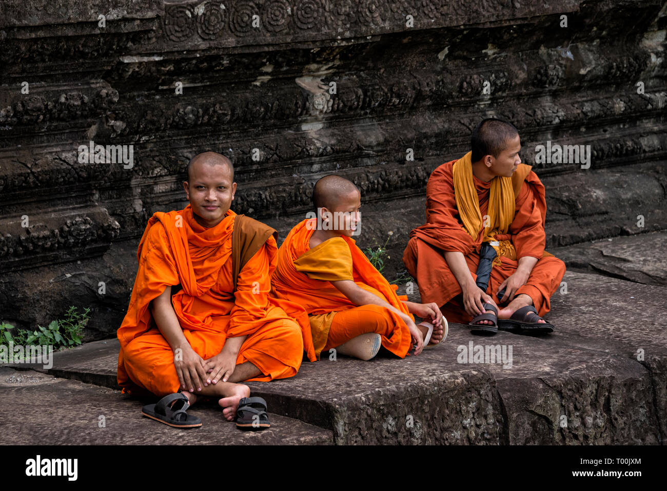 Group of Buddhist monks relaxing at Angkor Wat Temple in Siem Reap ...