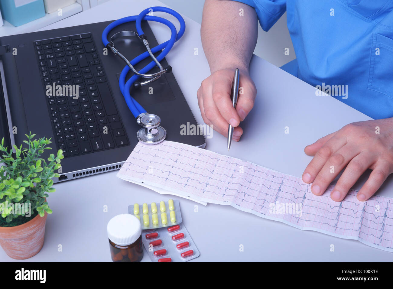 Close-up of doctor's hands writing prescription and holding bottle with ...