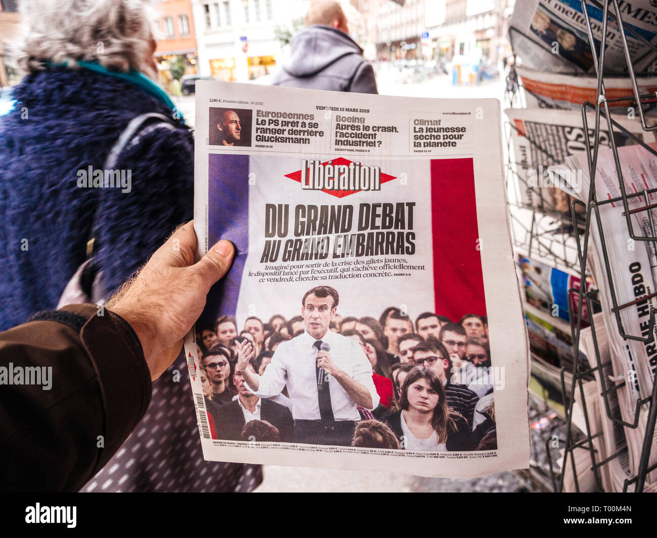 Paris, France - Mar 15, 2019: POV man shopping at press kiosk for ...