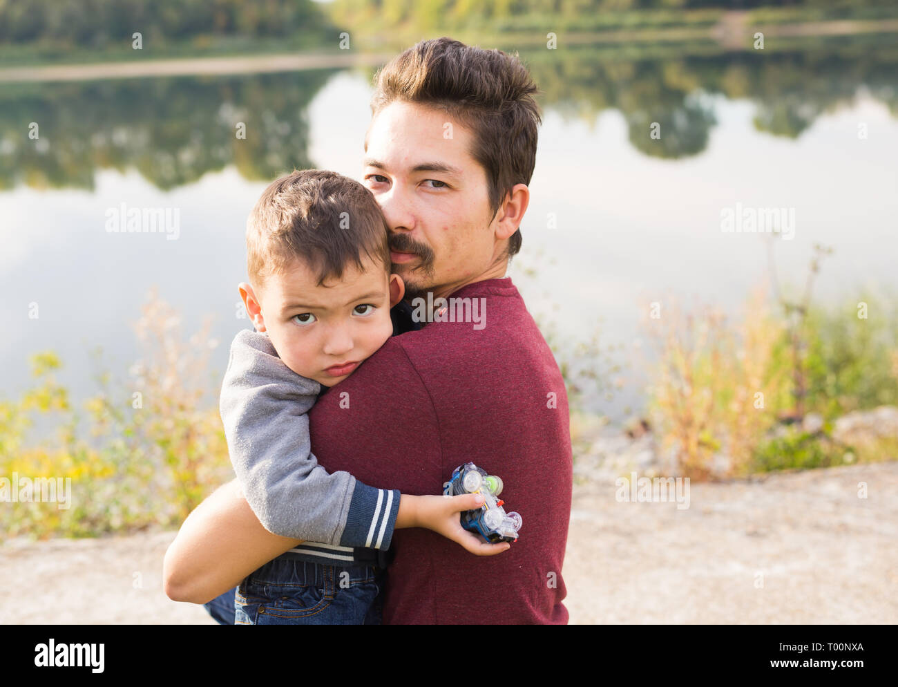 Fatherhood, family and parenthood concept - Father holding his baby son ...