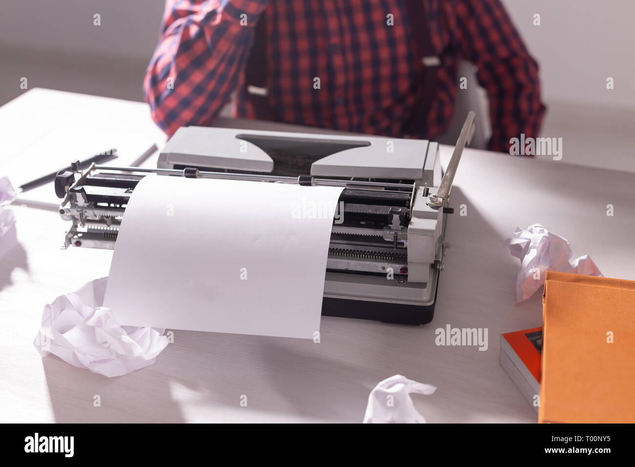 Writer's day and technology concept - Handsome writer surrounded by ...