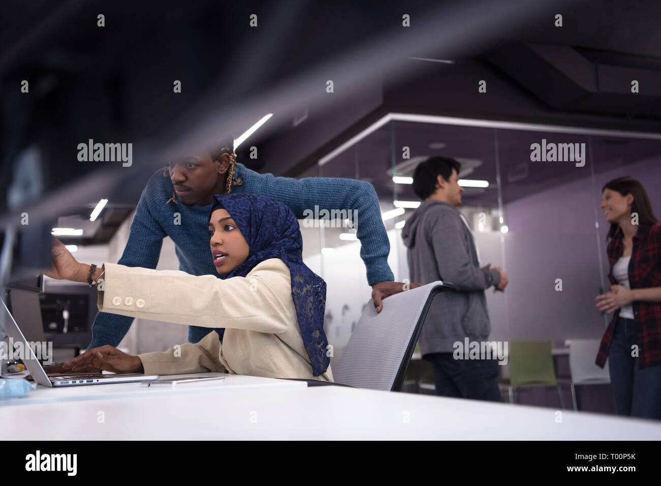 black muslim female software developer working together with her ...