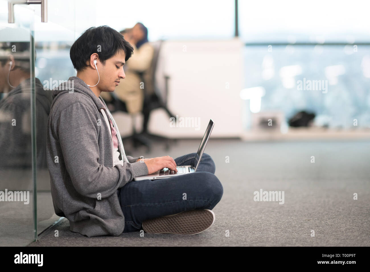 young indian software developer man using laptop computer writing ...
