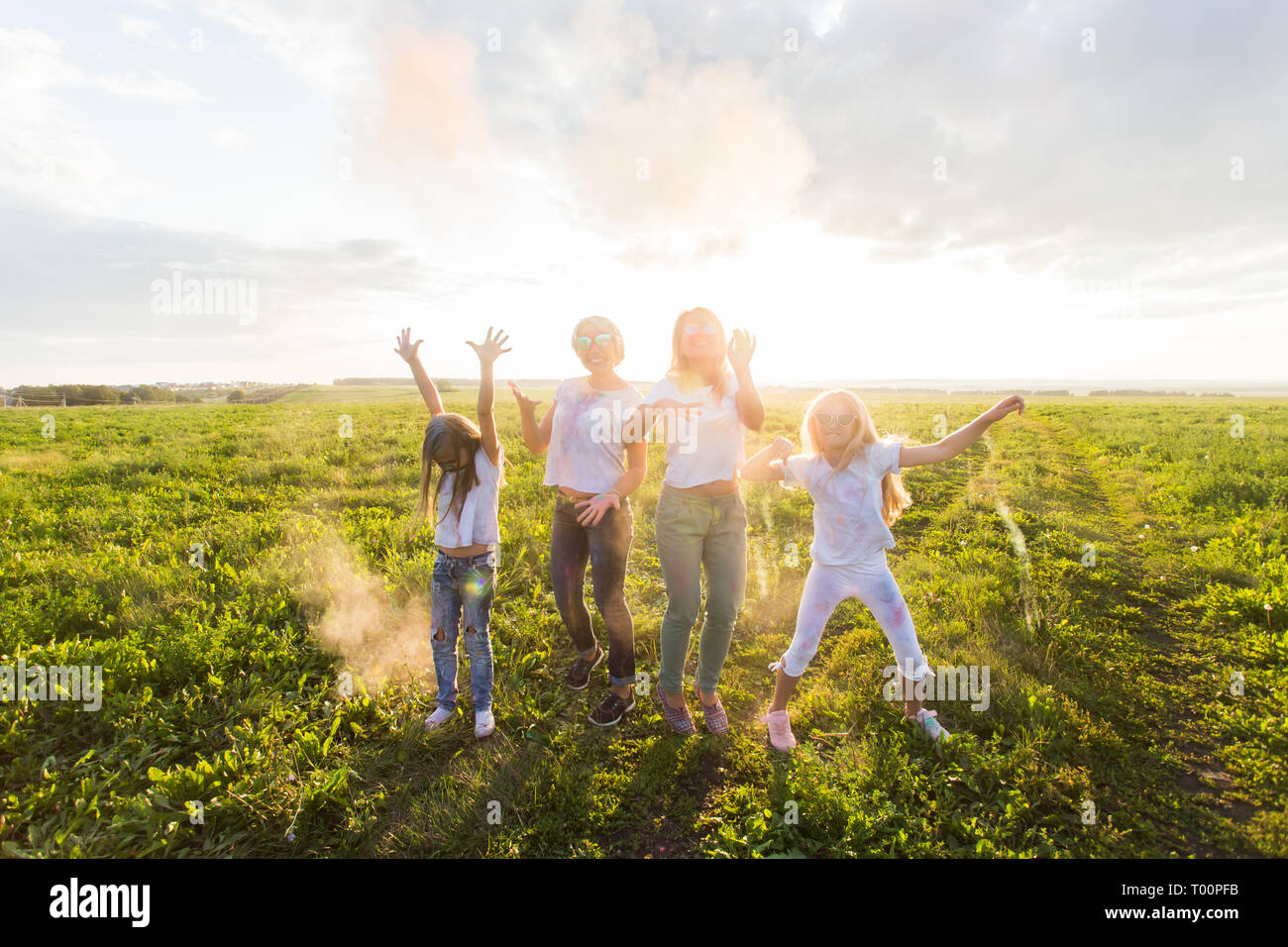 Indian holidays, fun and Holi festival concept - Jumping happy women ...