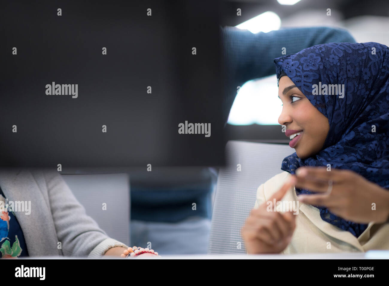 black muslim female software developer working together with her ...