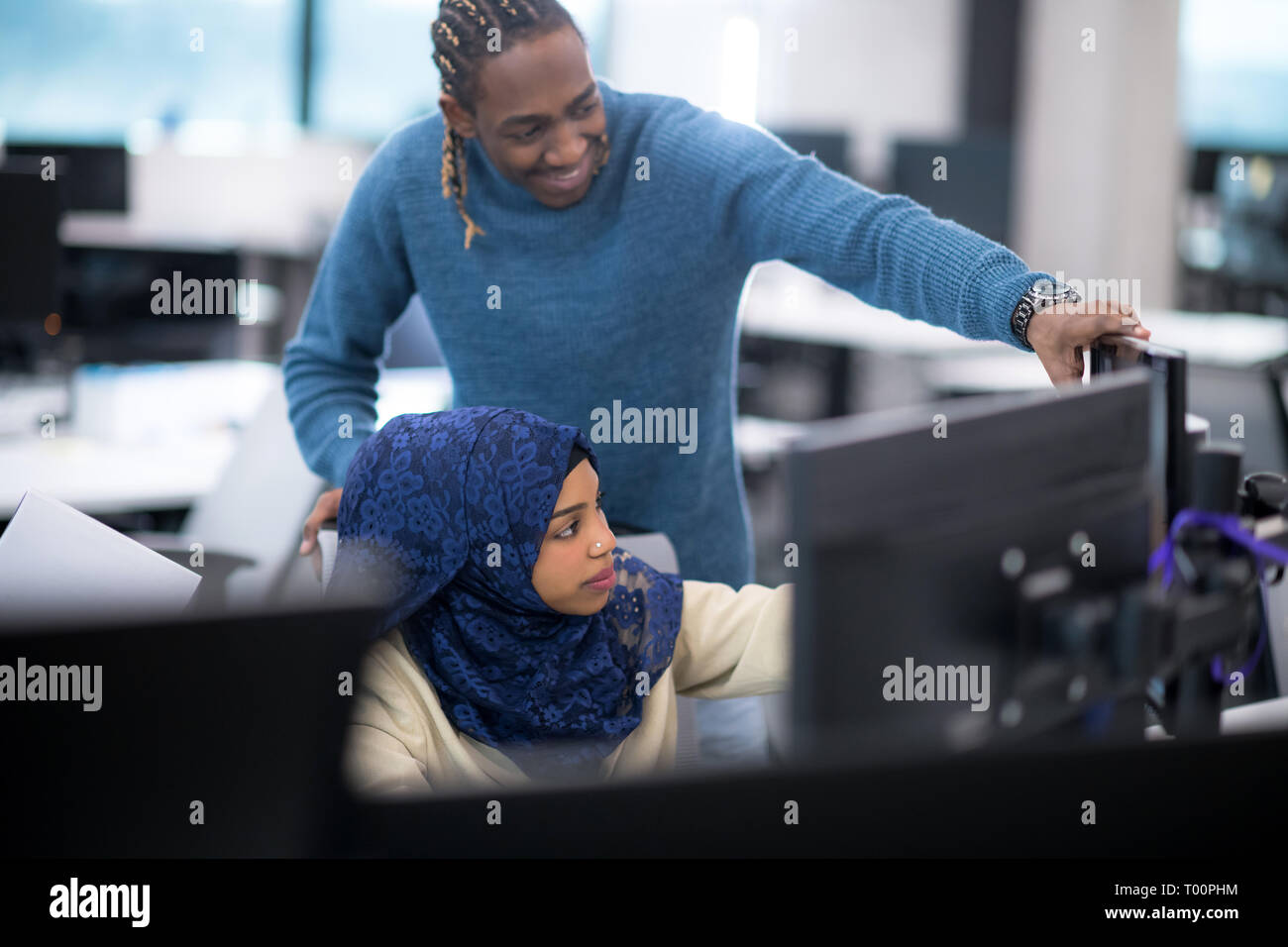 black muslim female software developer working together with her ...