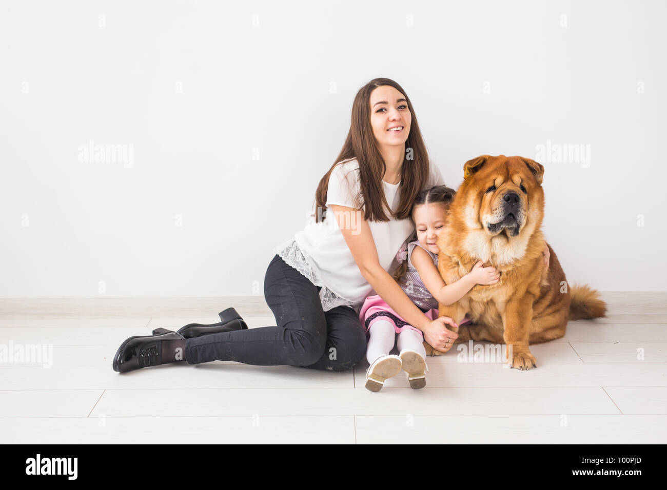 Pet, children and family concept - Little girl and her mother hugging ...