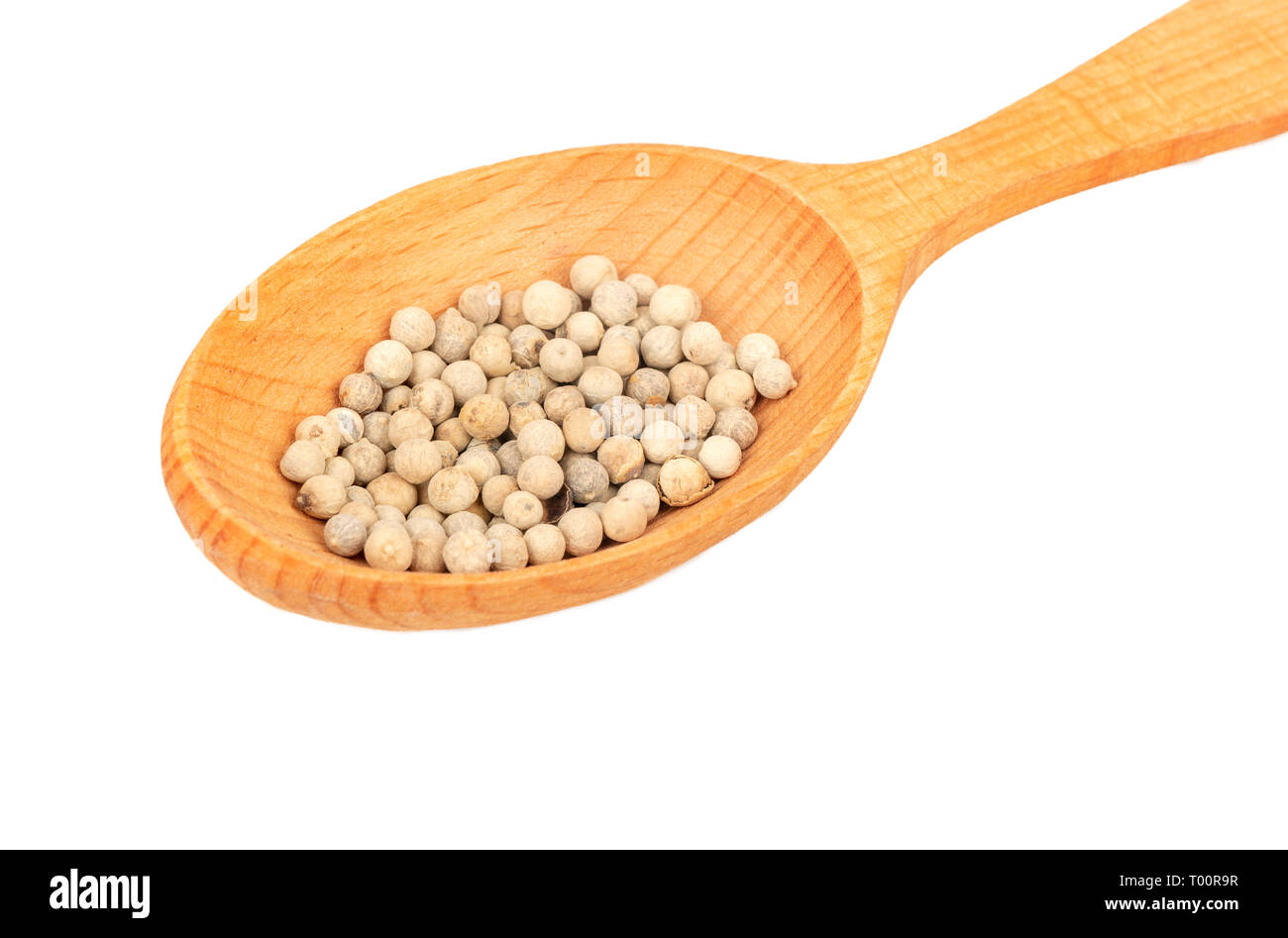 Wooden spoon with white pepper peas closeup on white background Stock ...