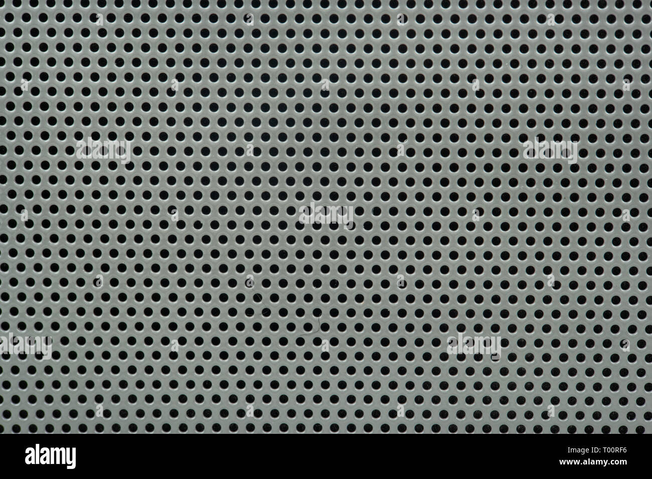 Gray background of metal mesh in the hole close-up Stock Photo - Alamy